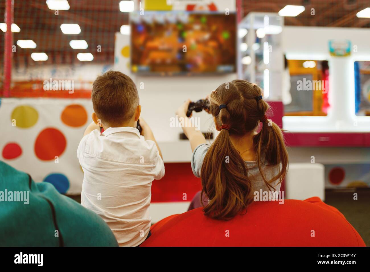 Children plays game console, entertainment center Stock Photo - Alamy