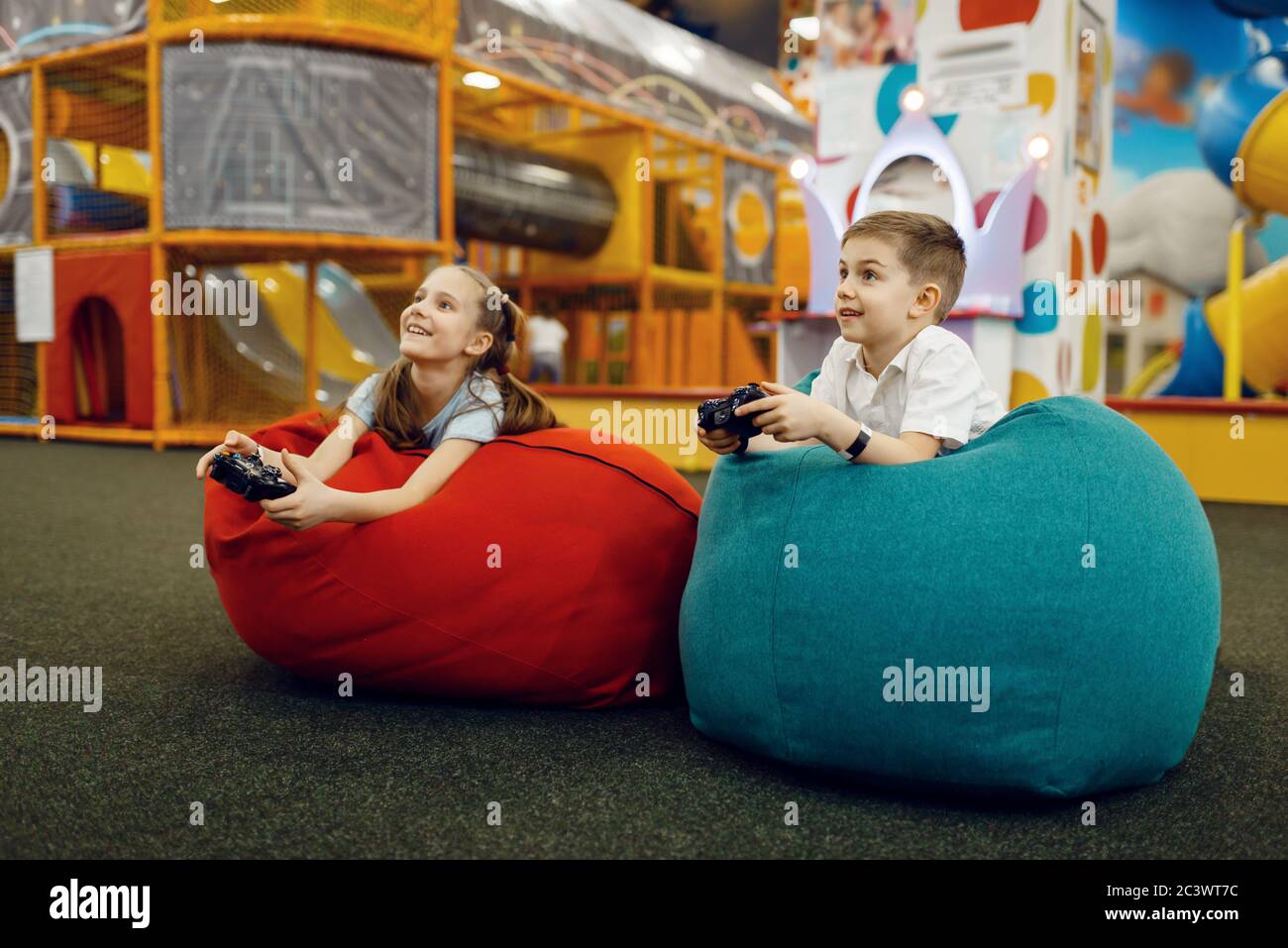 Children plays game console, entertainment center Stock Photo - Alamy