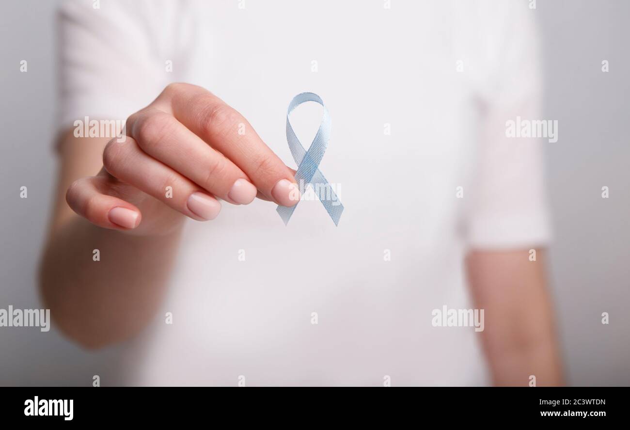 Woman holding Blue ribbon, Child Abuse awareness Stock Photo - Alamy