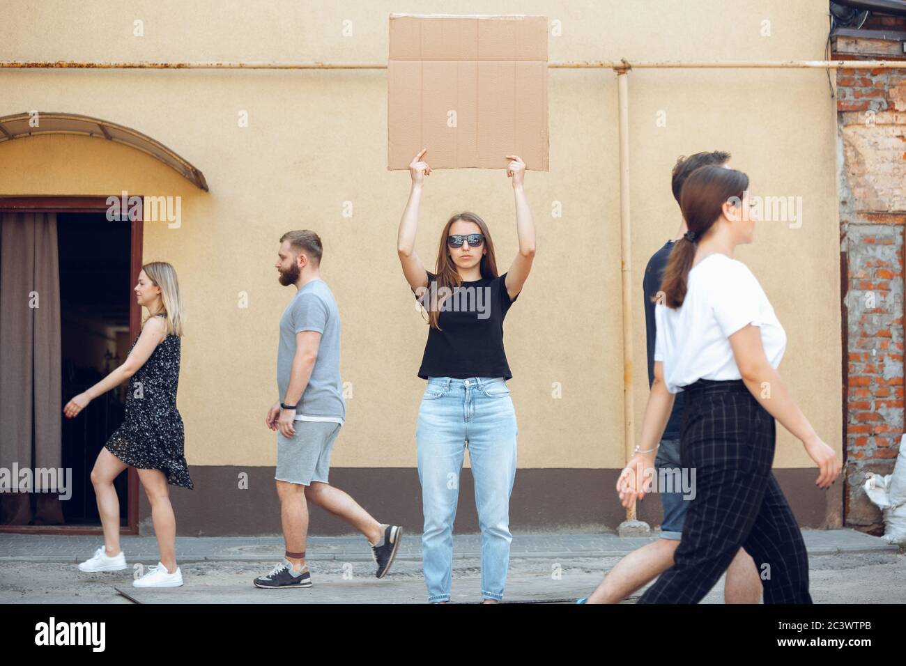 Dude with sign - woman stands protesting things that annoy her. Solo ...