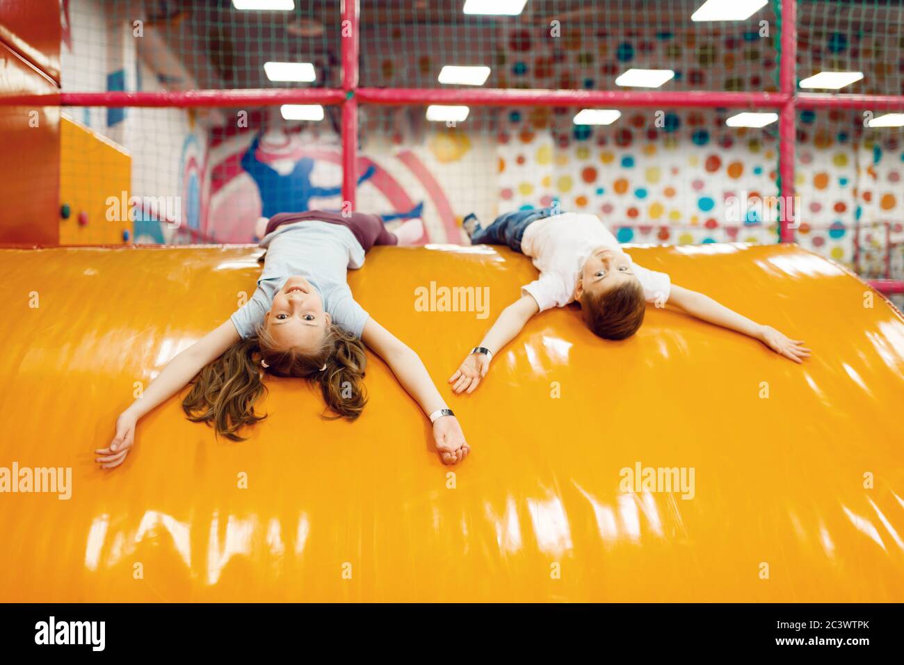 Children lying on mat in the entertainment center Stock Photo - Alamy