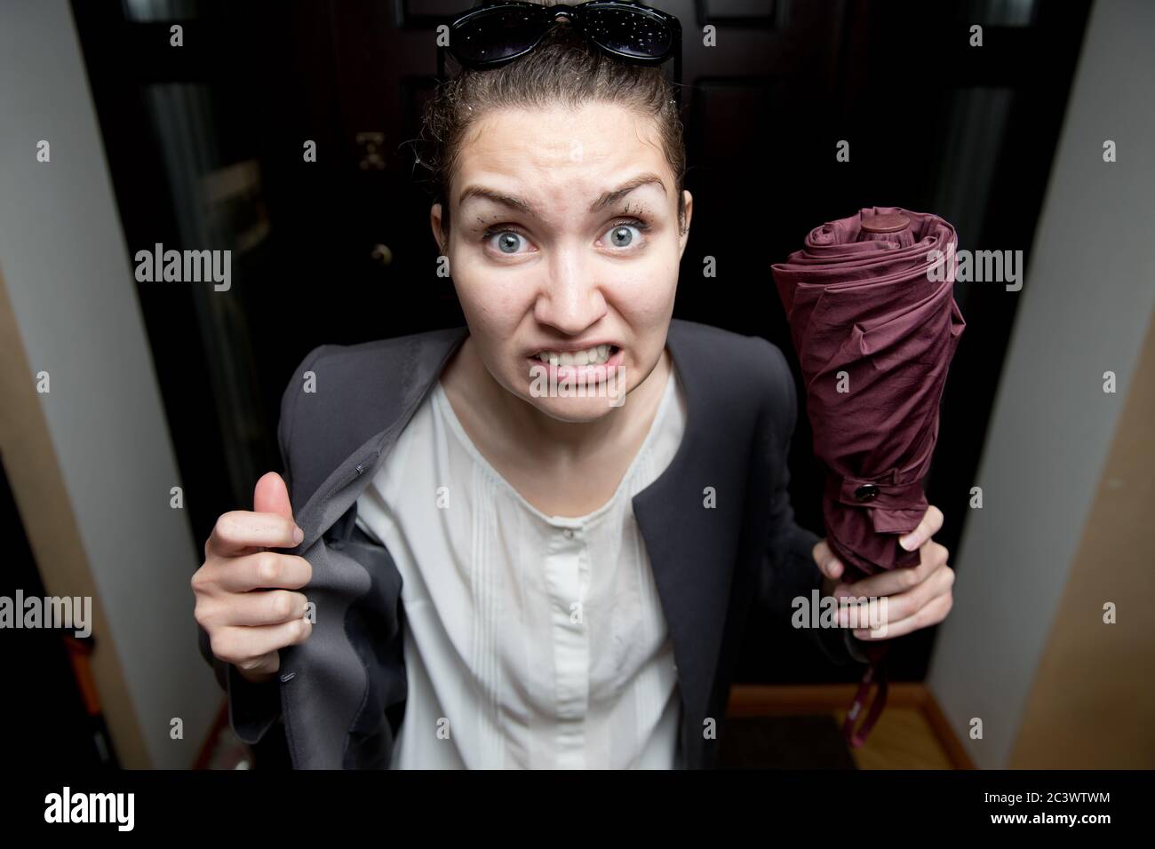 The woman is angry and screaming, she got wet in the rain and stands at ...