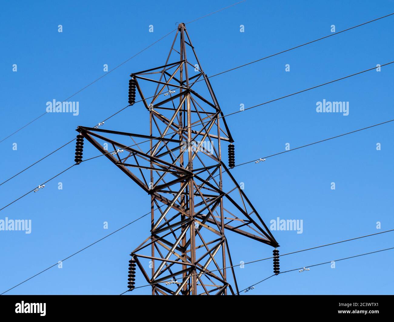 The top section of a high voltage hydro electricity distribution tower ...