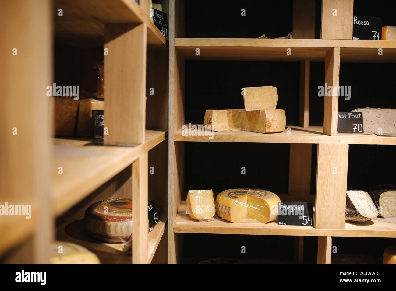 Shelf with cheese in cheese store. Assortment of different cheese types ...