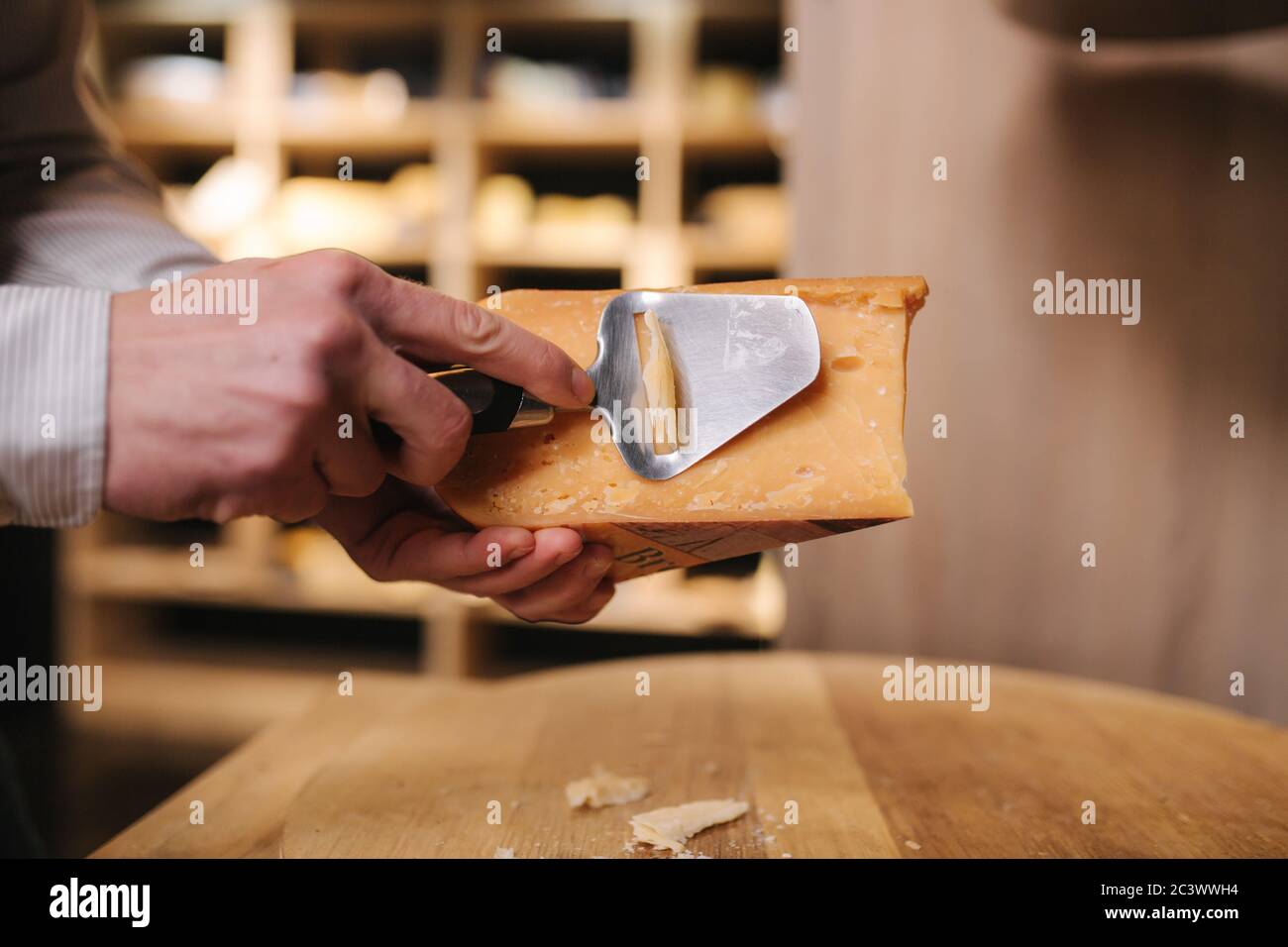 Young man cheese wheel hi-res stock photography and images - Alamy