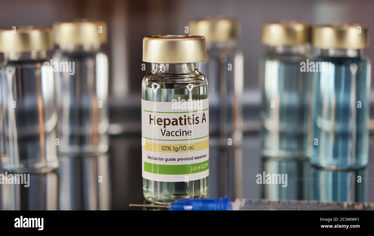 Vial of Hepatitis A injection with a syringe on a stainless steel ...