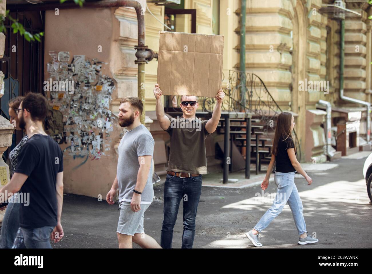 Dude with sign - man stands protesting things that annoy him. Solo ...