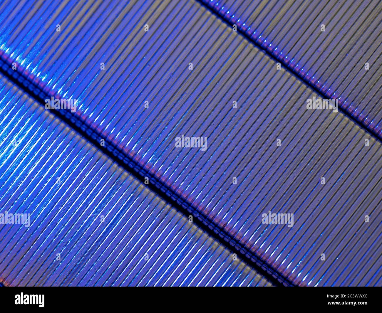 Cobalt blue and purple illuminated diagonally placed metal staples ...