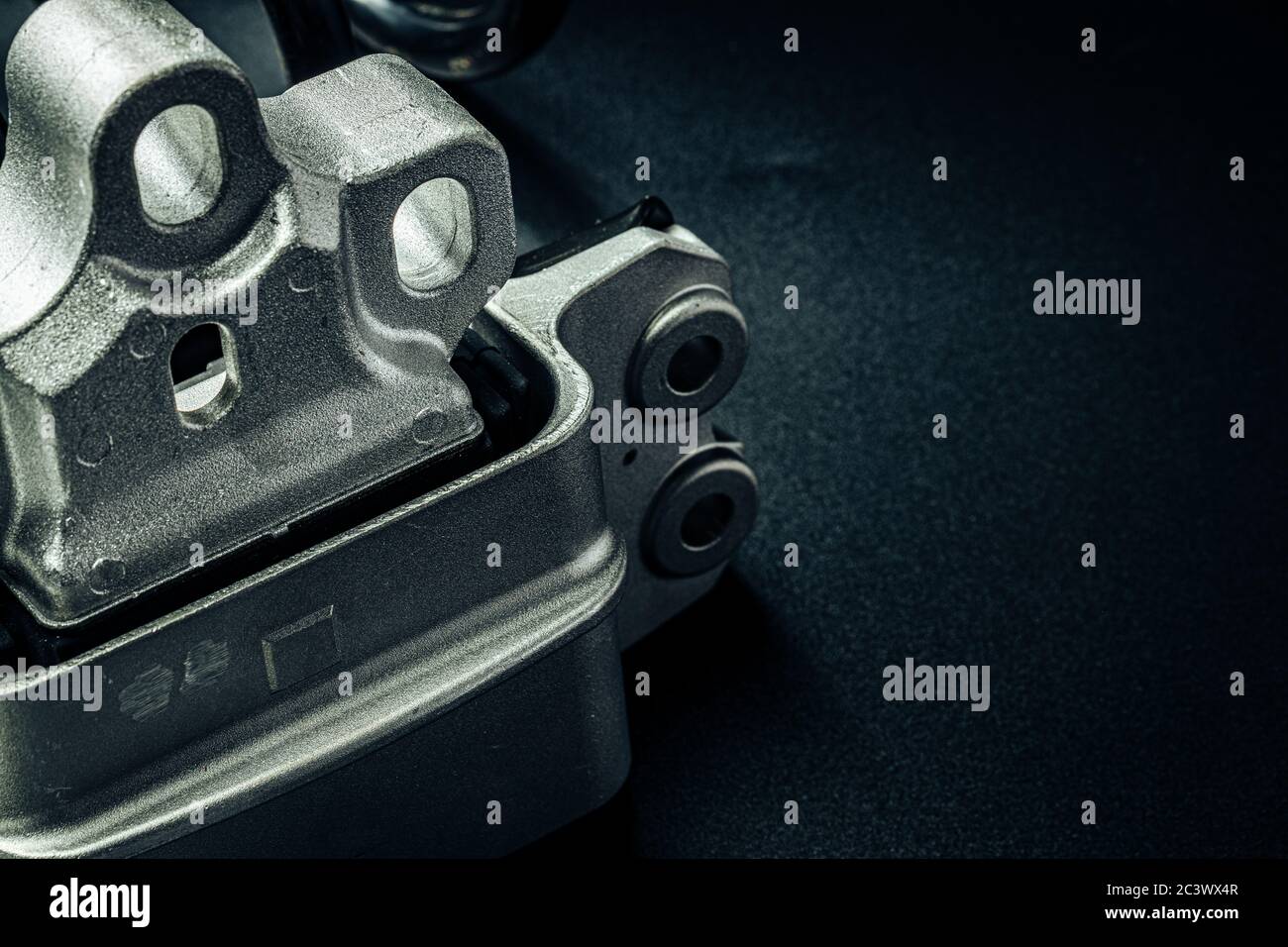Metal car engine spare part on black background Stock Photo - Alamy