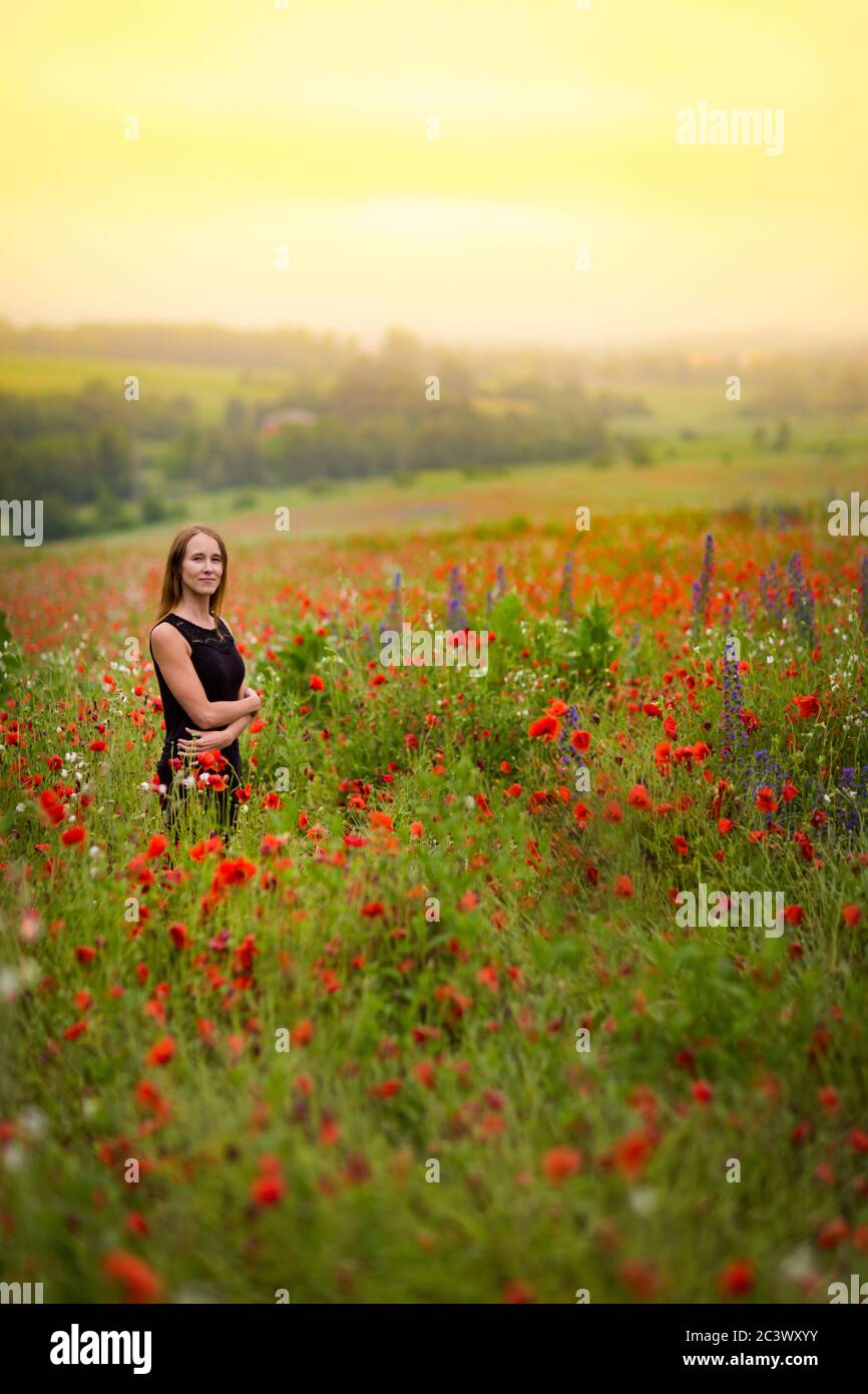 Woman in poppy field hi-res stock photography and images - Alamy