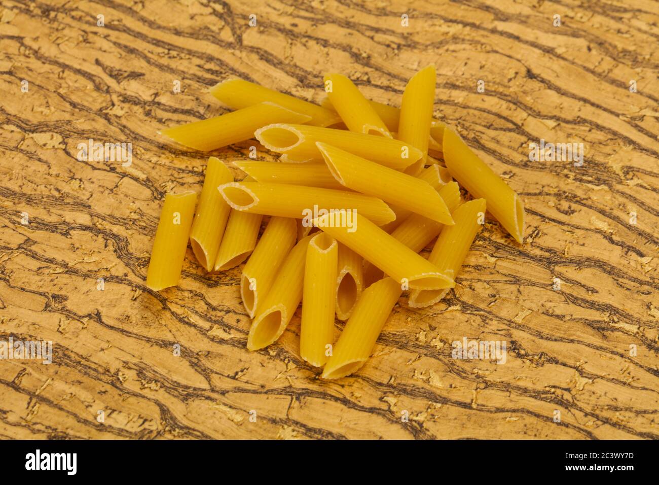 Raw penne pasta ready for bowl Stock Photo - Alamy