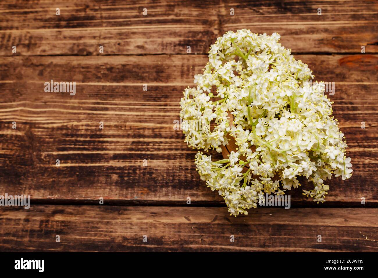 Fragrant bouquet of fresh elder flowers. Old wooden boards background ...