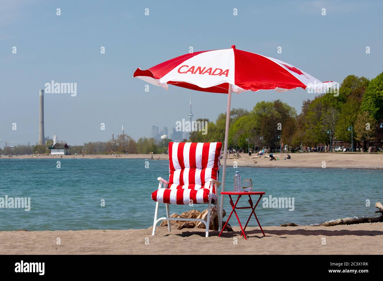 A Canadian flag umbrella and red striped beach chair with the Toronto ...