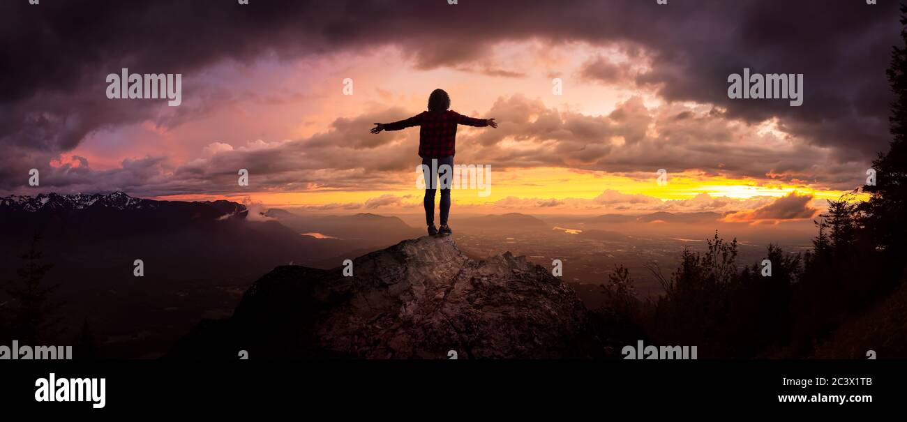 Fantasy Adventure Photo with a Girl on top of a Rock Cliff Stock Photo ...