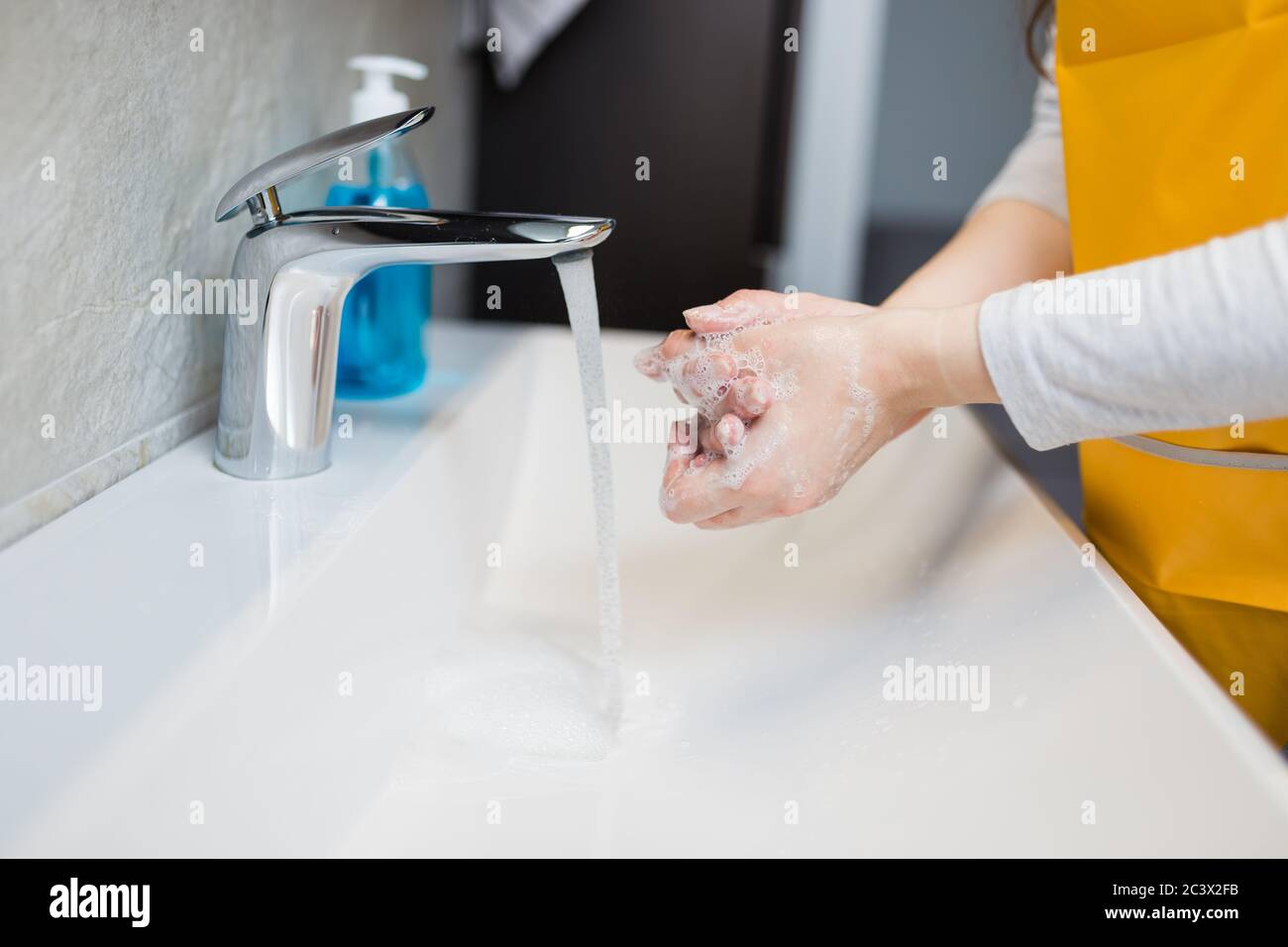 Washing hands under the water tap or faucet. Hygiene concept detail ...