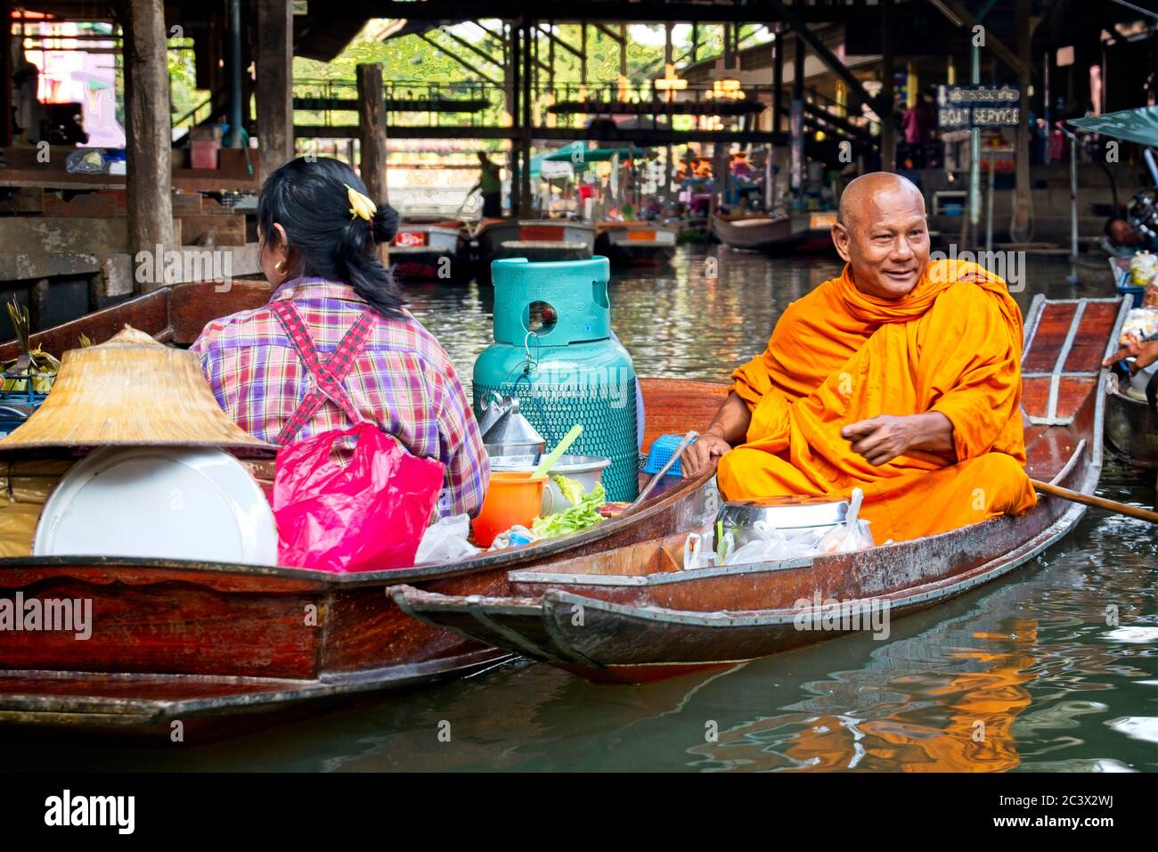 Bhudist monks and locals at Bangkoks floating market Woman and monk in ...