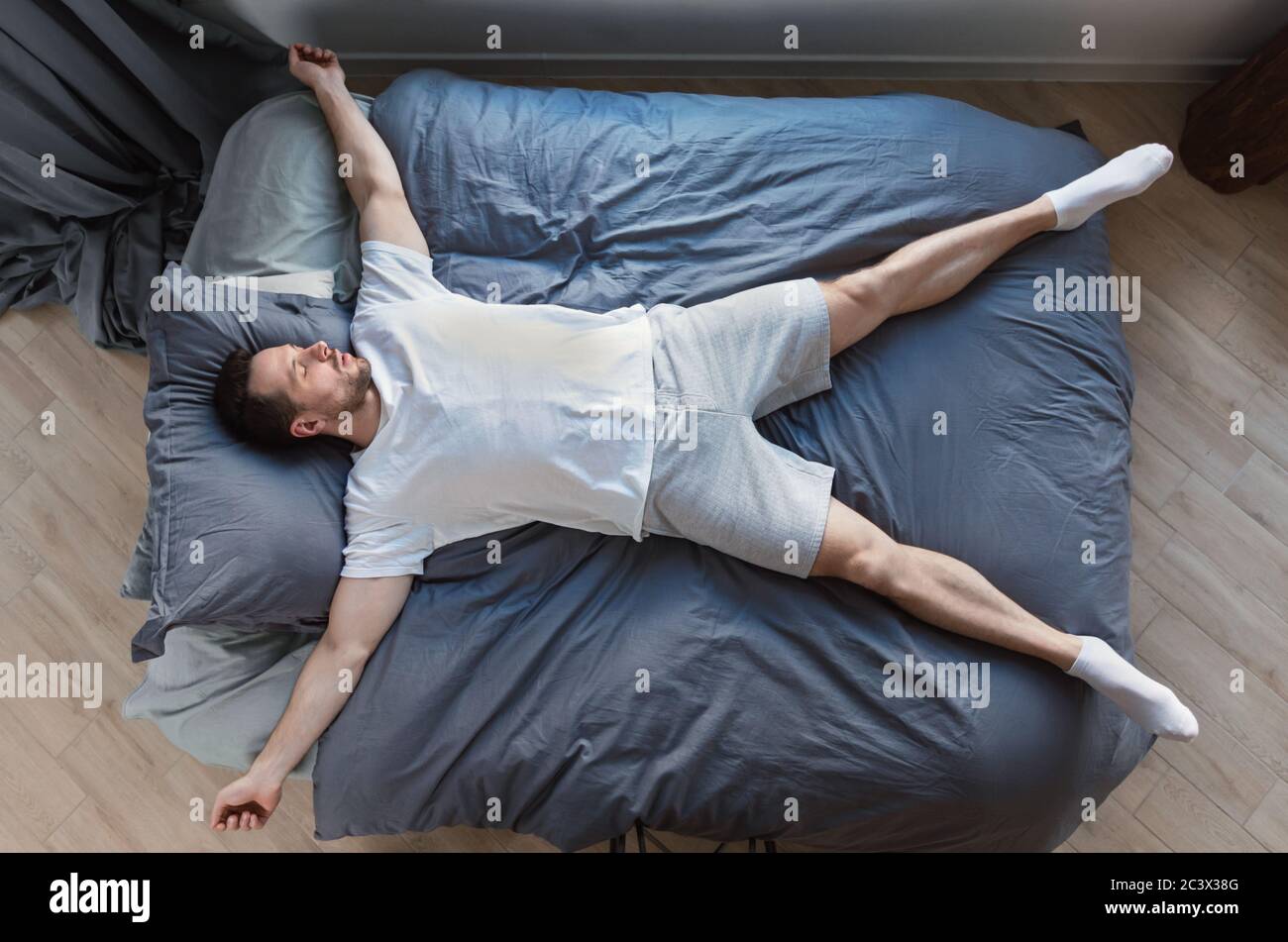 Man Sleeping Lying On Back In Bed At Home, Top-View Stock Photo - Alamy