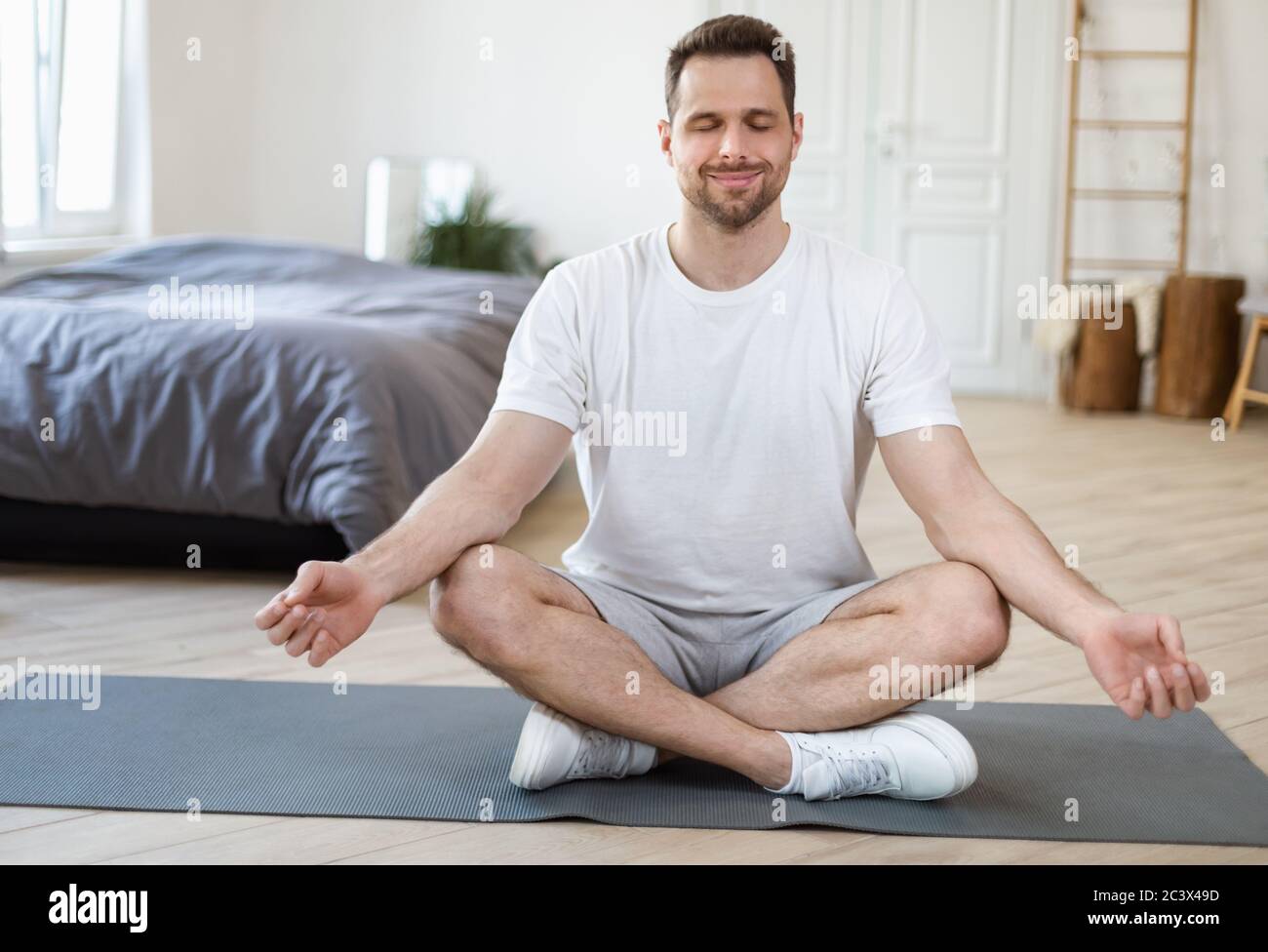 Man Meditating Sitting In Lotus Position Relaxing At Home Stock Photo ...