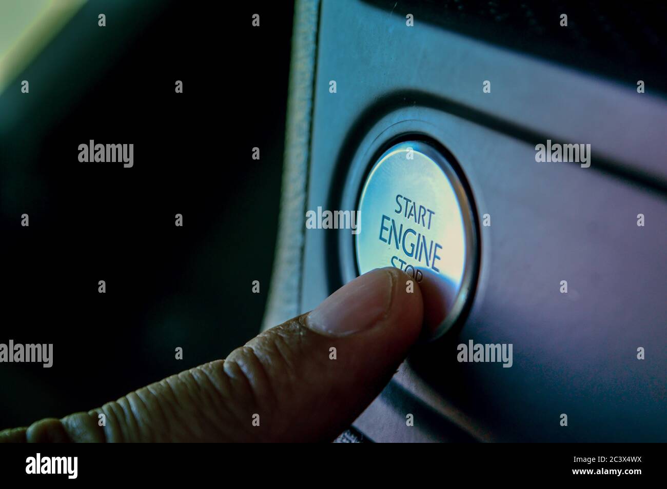 Male finger depressing a luxury vehicles push to start ignition Stock ...