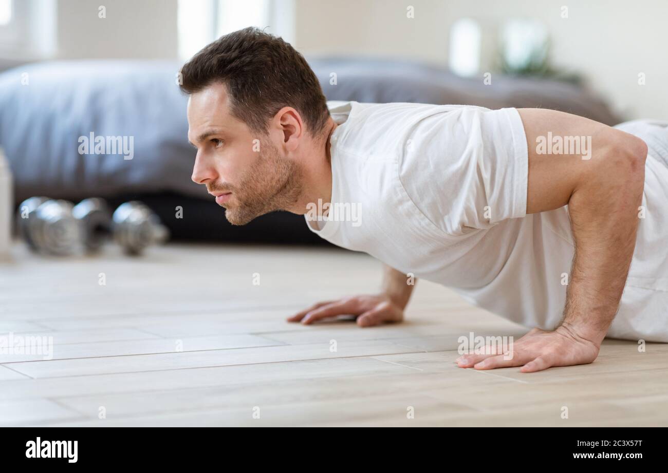 Sporty Man Doing Push-Ups Exercise Training Indoor On Weekend Stock ...