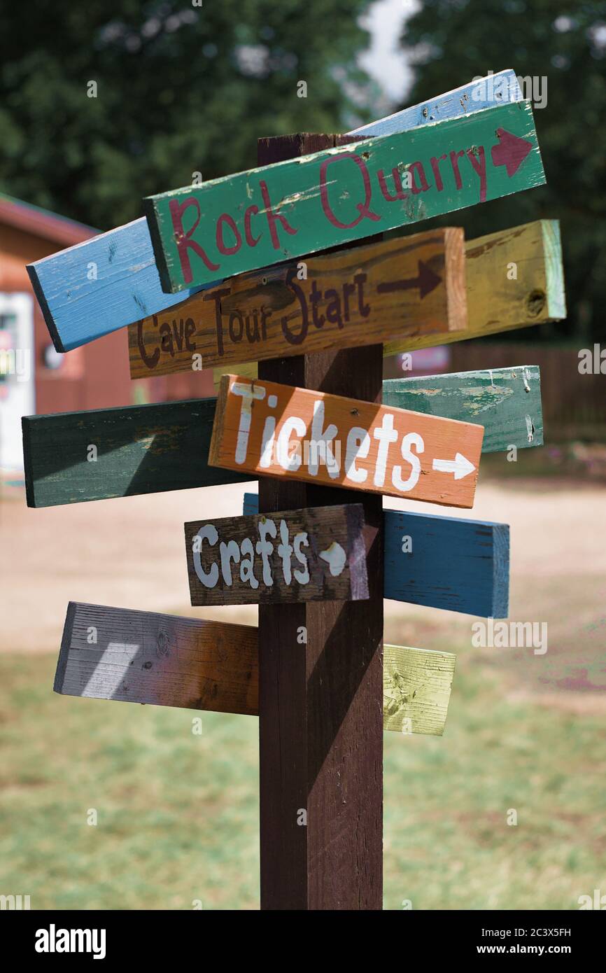 Wood sign arrow paths to activities and ticket booth for cave rock ...