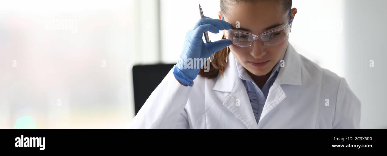 Scientist noting information of researching Stock Photo - Alamy