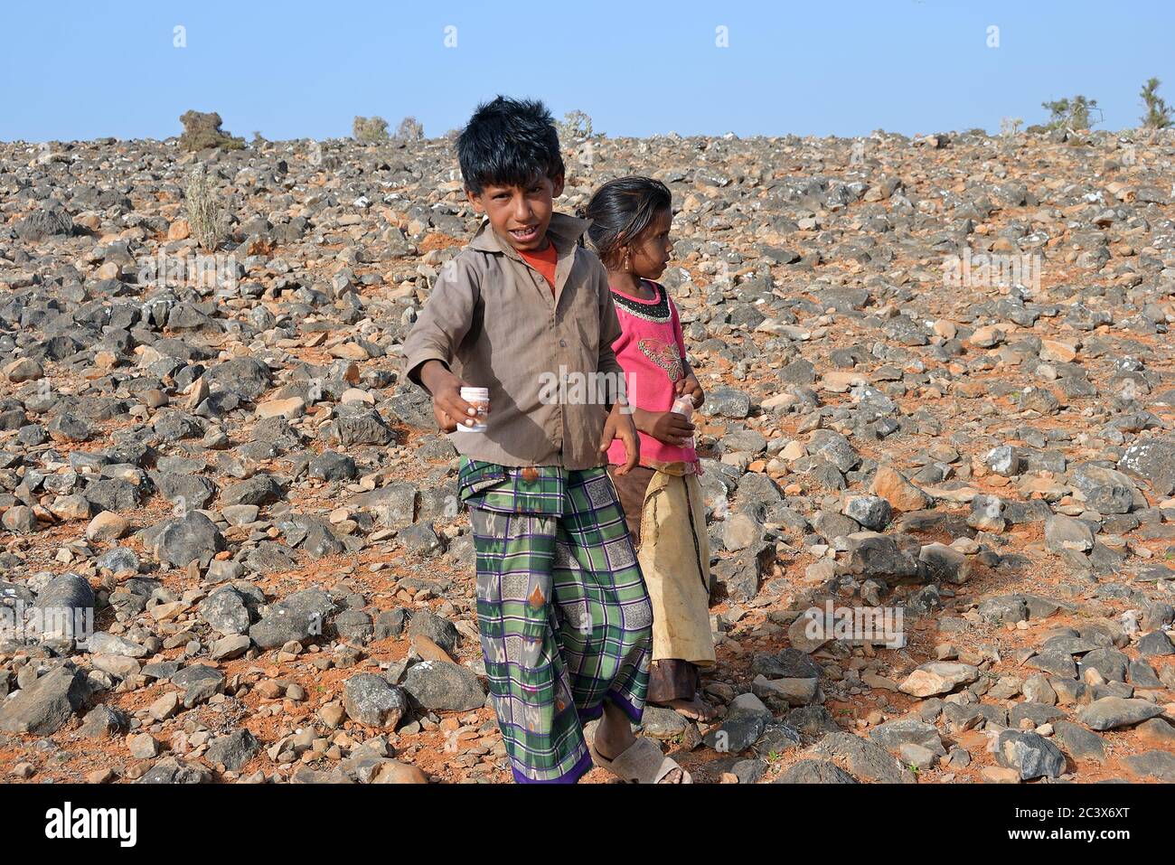 Socotra, Yemen - March 8, 2010: Young boy and his little sister sale a ...