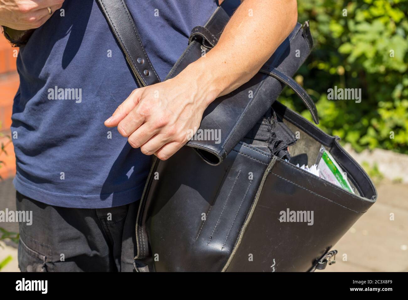 Postman delivering parcels, Bag of a postal worker, Full of letters ...