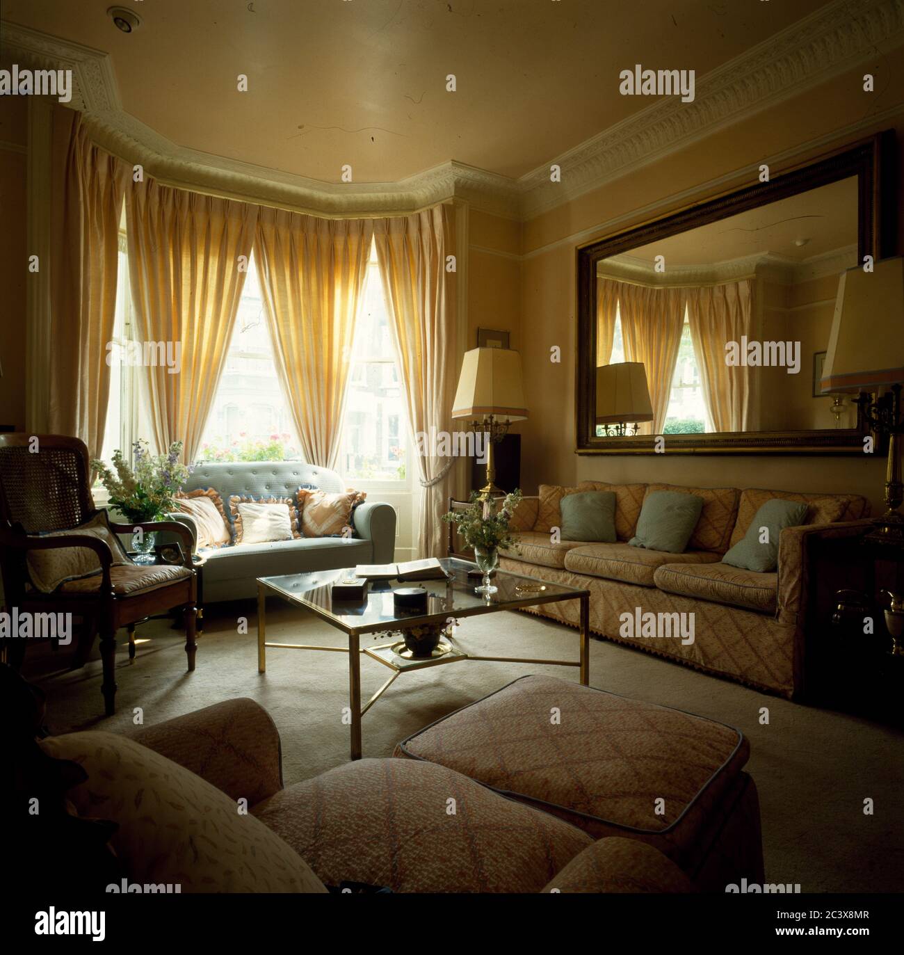 Designer living room with sofas and drapes in bay window Stock Photo ...