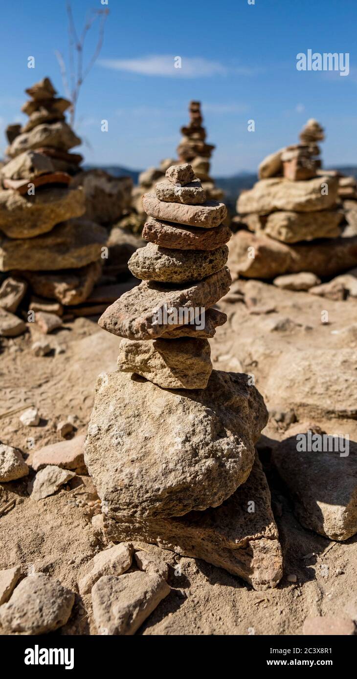 Vertical piles of rocks stacked near the famous bridge in Ronda. Close ...