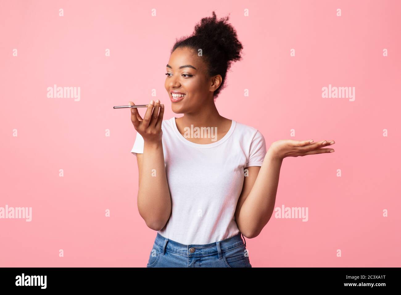 Happy afro lady using voice assistant on smartphone Stock Photo - Alamy