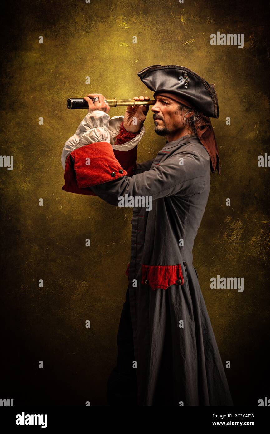 Portrait of a pirate, holding a spotting scope in his hands Stock Photo ...