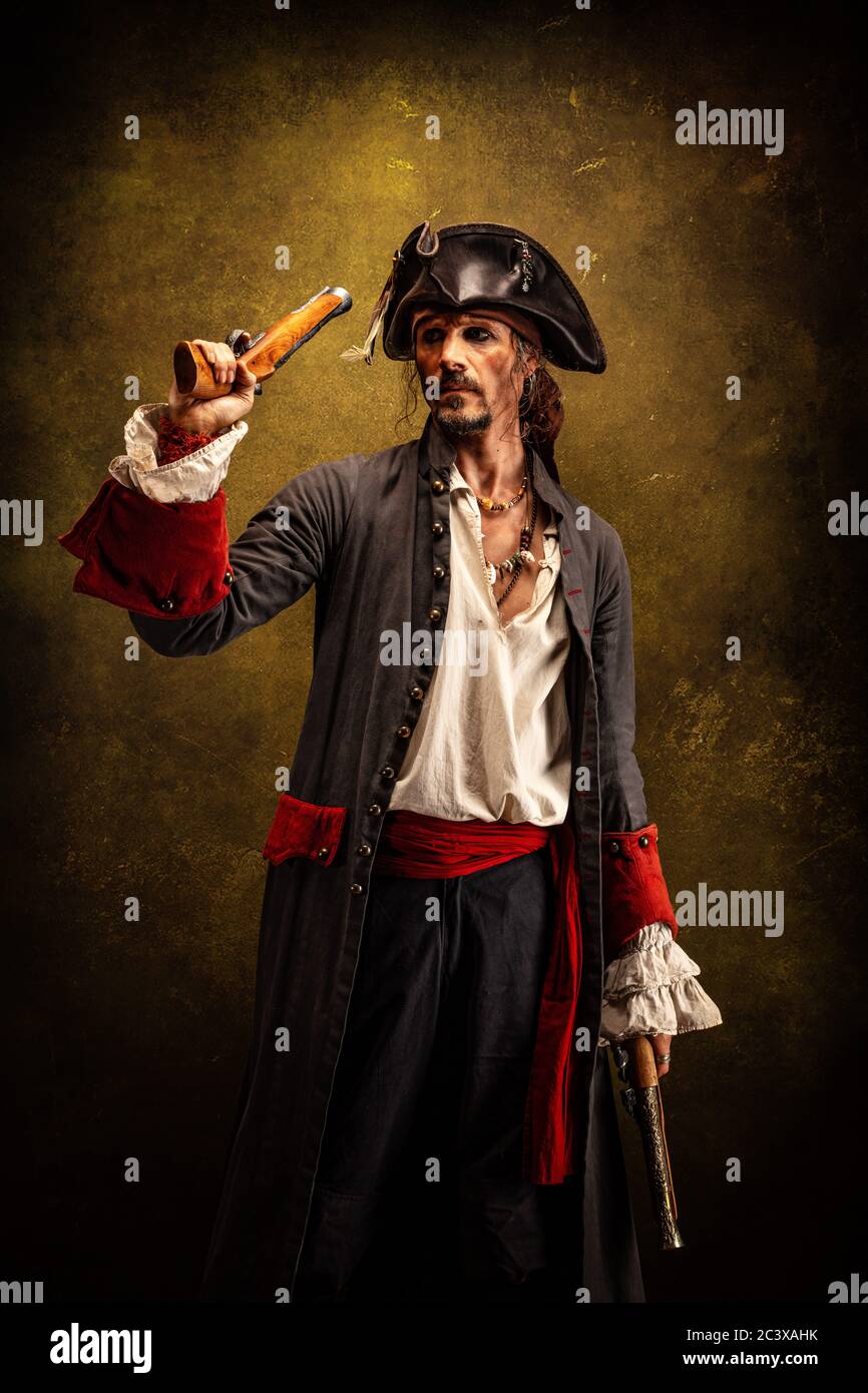 Portrait of a pirate, holding a musket gun in his hand Stock Photo - Alamy