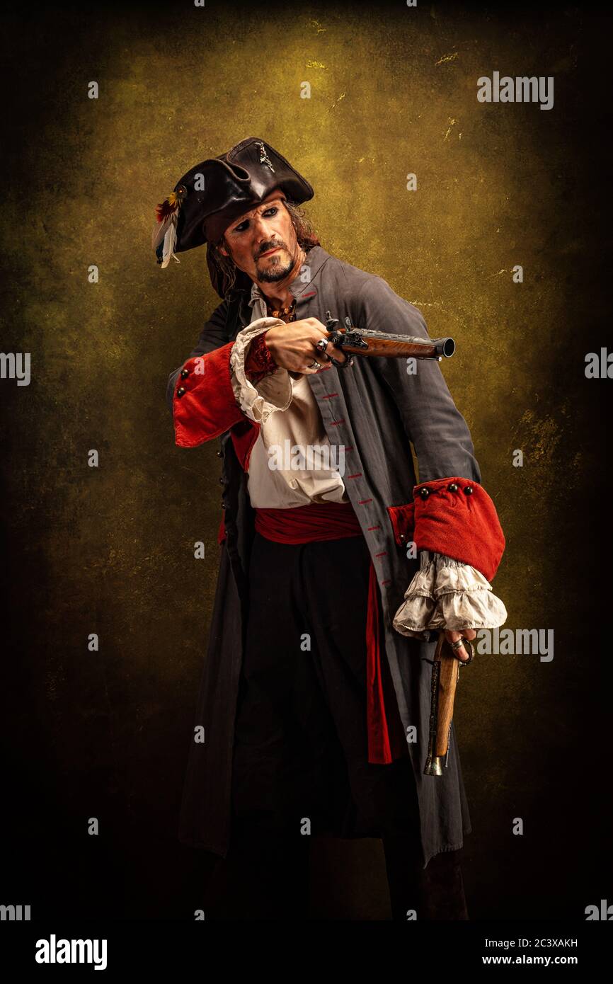 Portrait of a pirate, holding a musket gun in his hand Stock Photo - Alamy