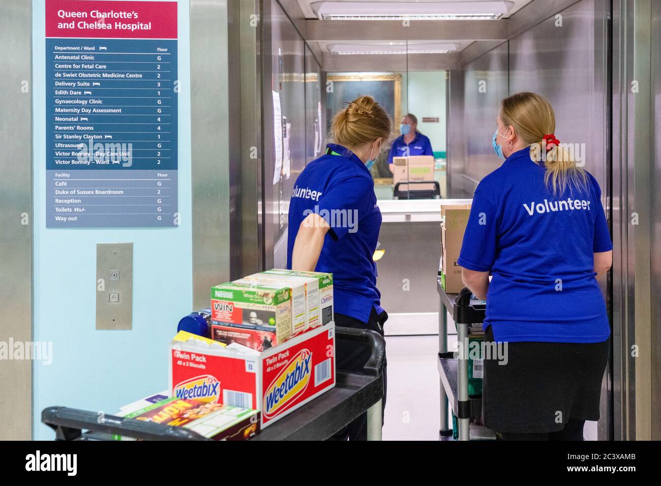 Two NHS volunteers delivering food to staff in Hammersmith Hospital in ...