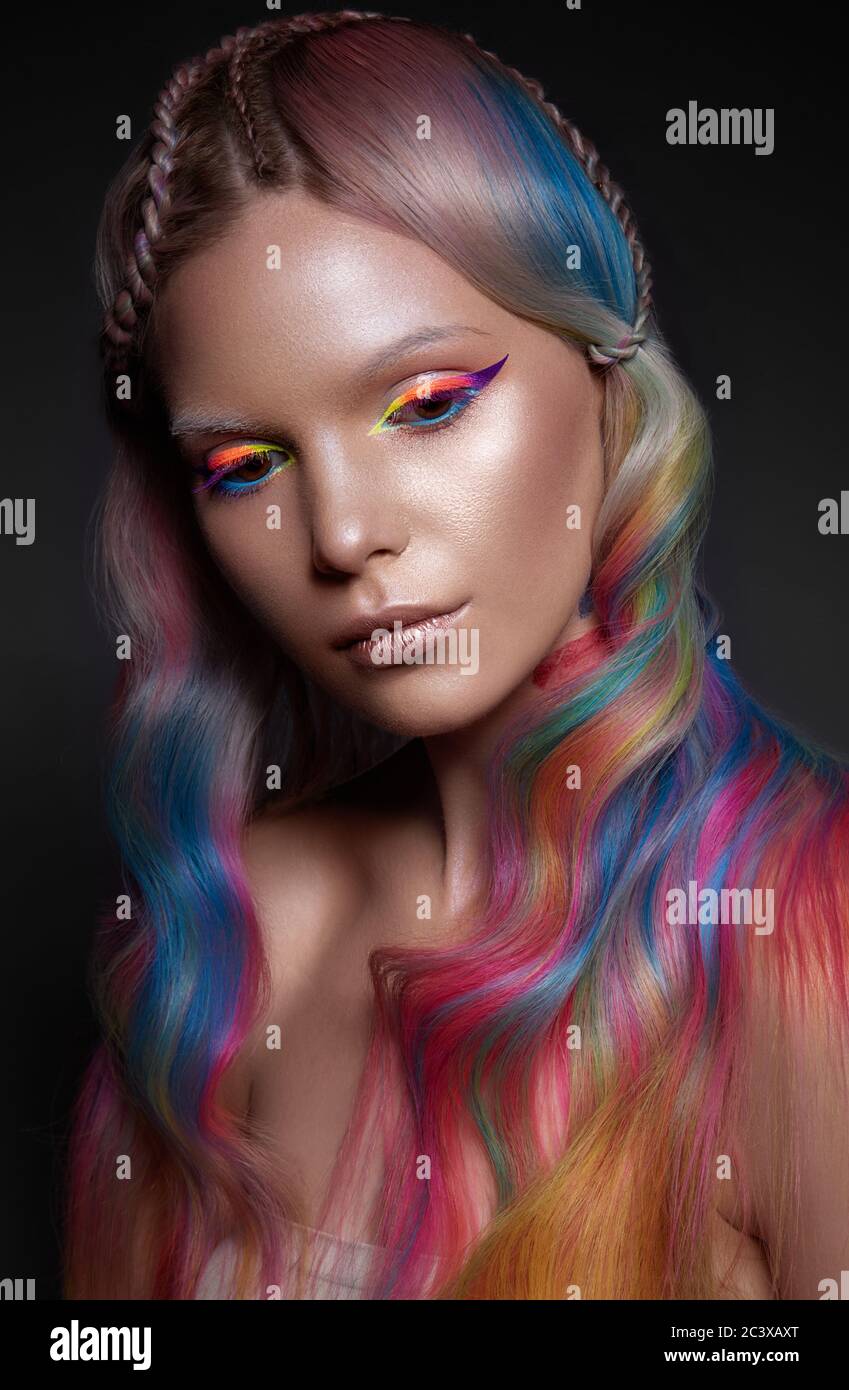 Beautiful girl with multi-colored hair and creative make-up and ...