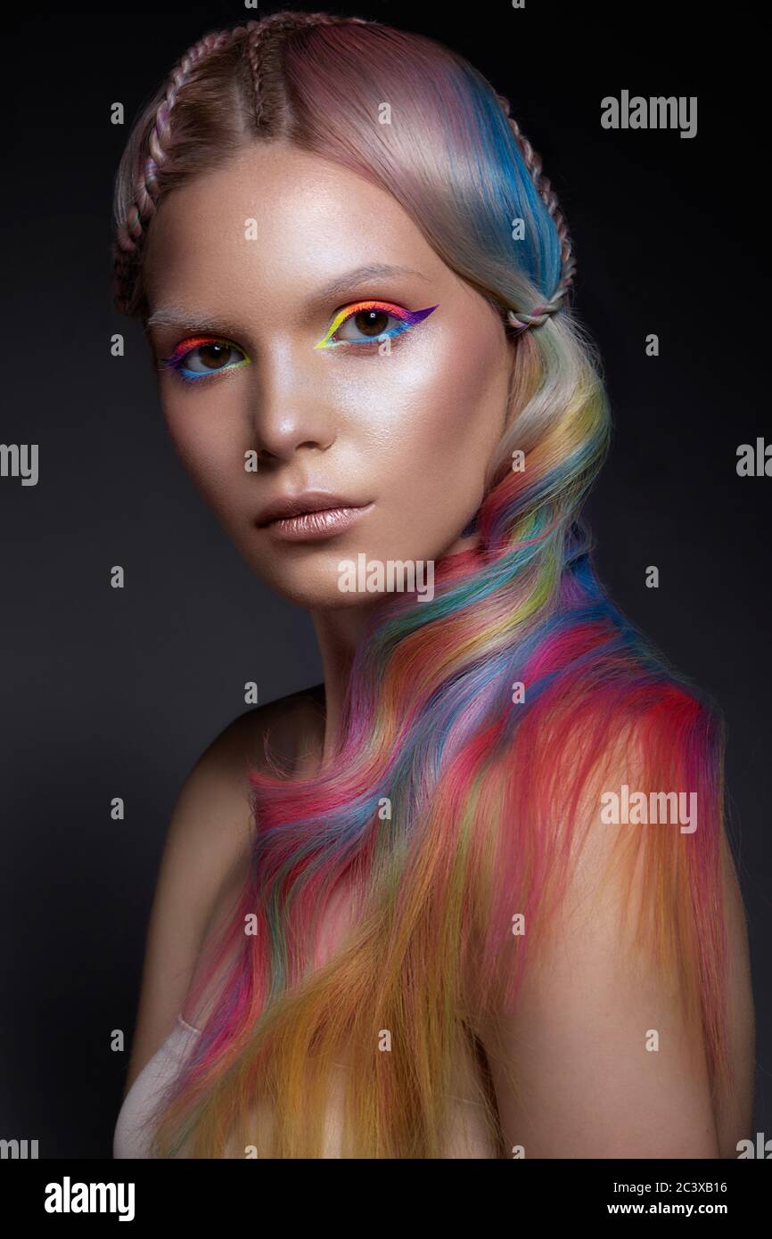 Beautiful girl with multi-colored hair and creative make-up and ...