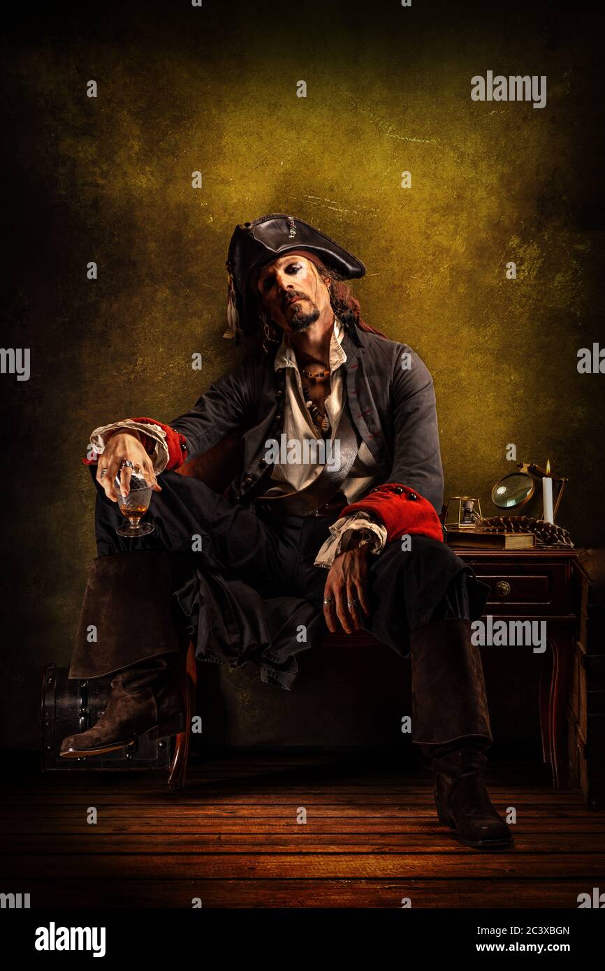 Portrait of a pirate drinking rum, sitting in a tavern Stock Photo - Alamy