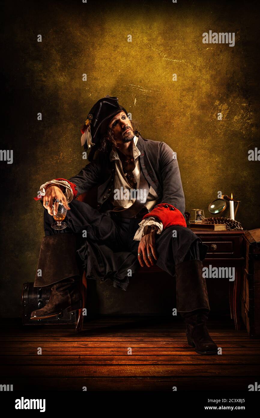 Portrait of a pirate drinking rum, sitting in a tavern Stock Photo - Alamy