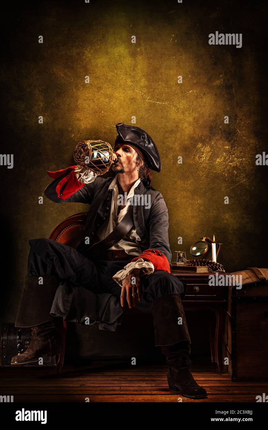 Portrait of a pirate drinking rum, sitting in a tavern Stock Photo - Alamy