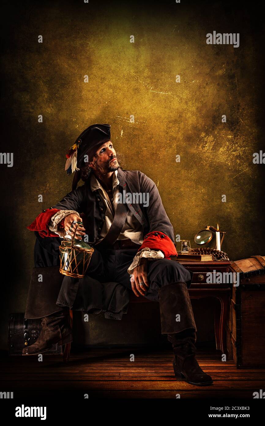 Portrait of a pirate drinking rum, sitting in a tavern Stock Photo - Alamy