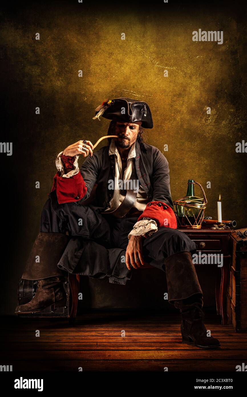 Portrait of a pirate smoking a pipe, sitting in a tavern Stock Photo ...