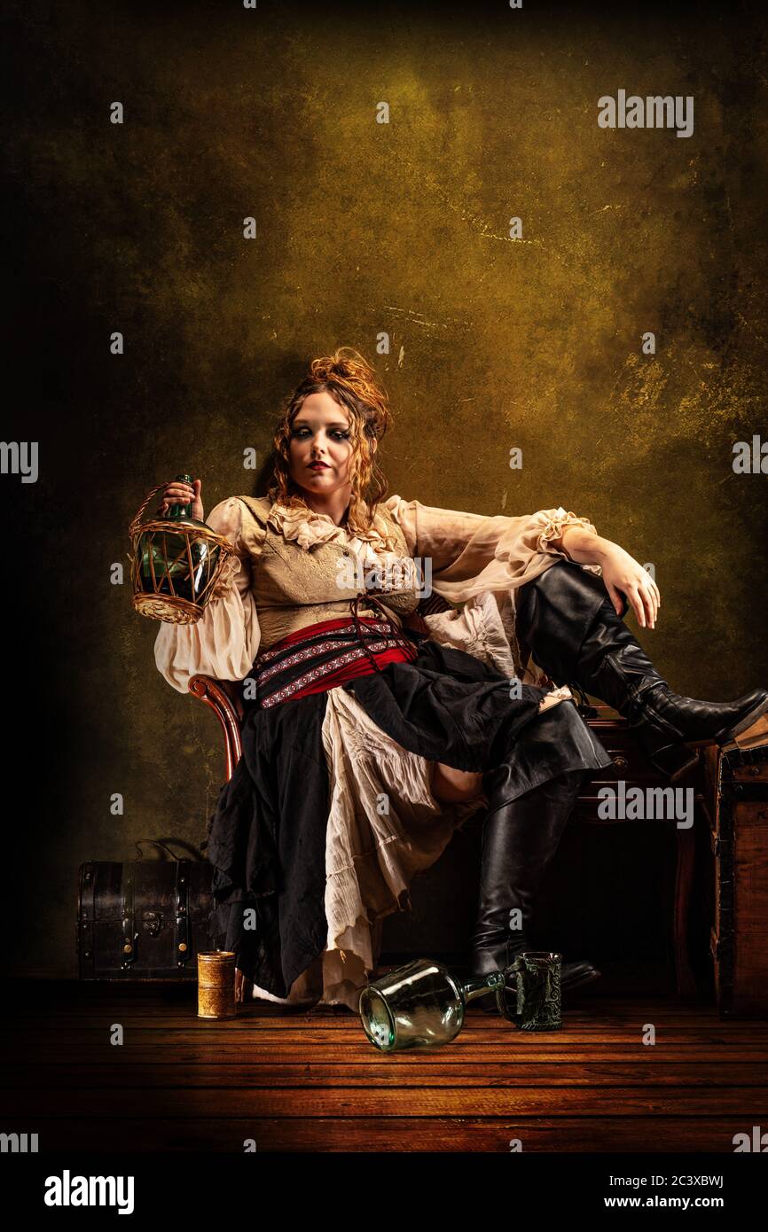 Portrait of a cheerful girl drinking rum in a tavern Stock Photo - Alamy