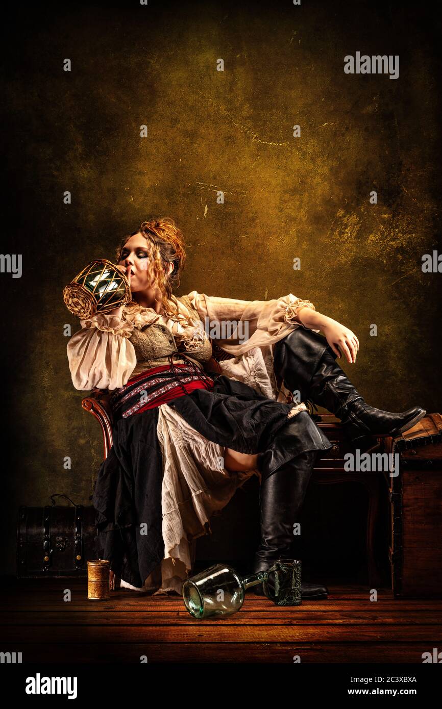Portrait of a cheerful girl drinking rum in a tavern Stock Photo - Alamy