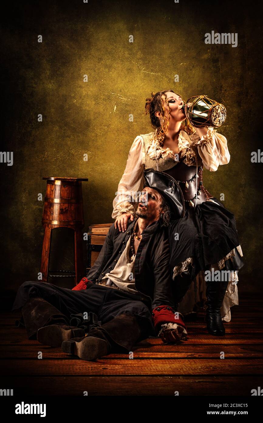 Portrait of a couple of pirates drinking rum in a tavern Stock Photo ...