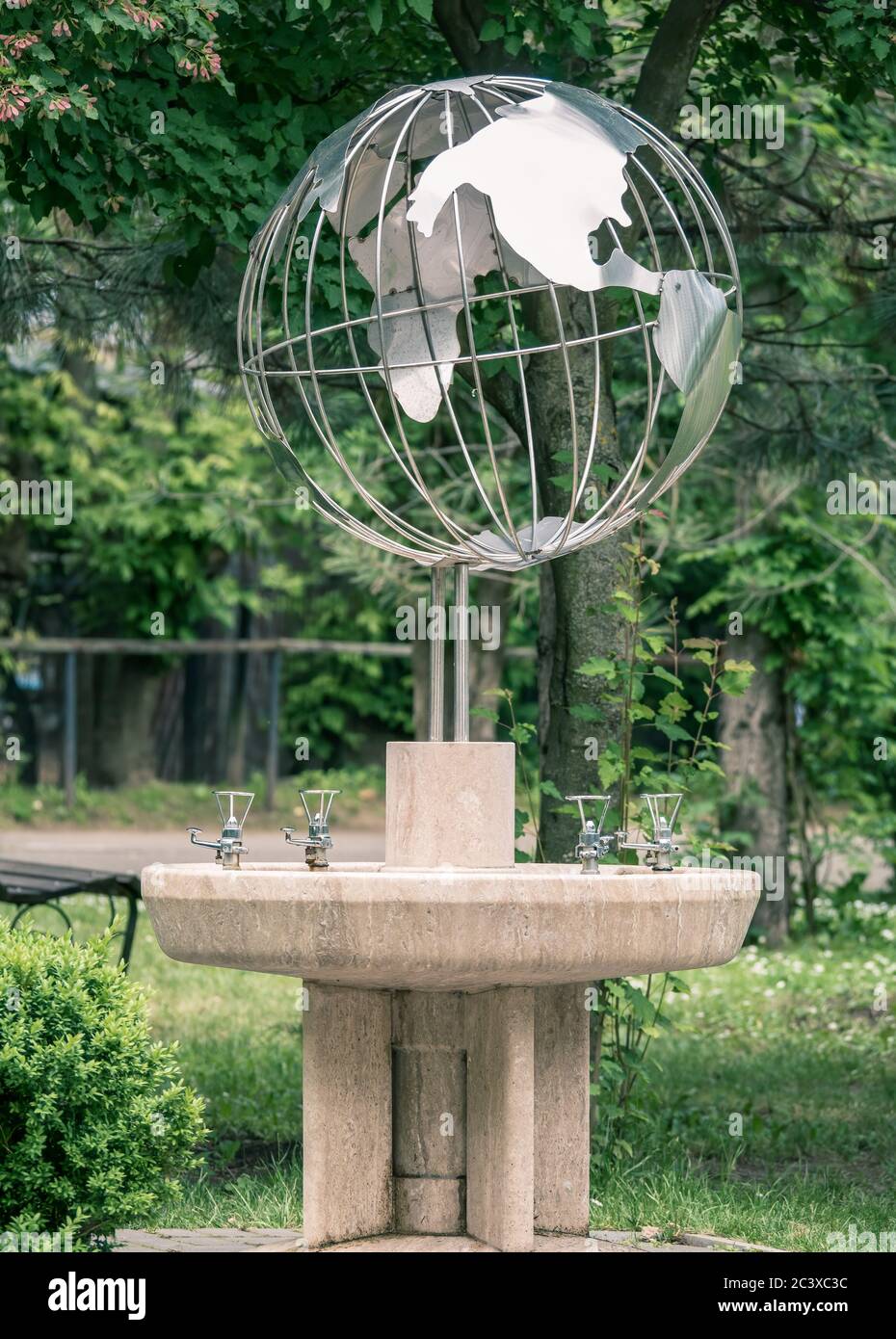 Drinking and washing water taps or fountains with the earth globe on ...