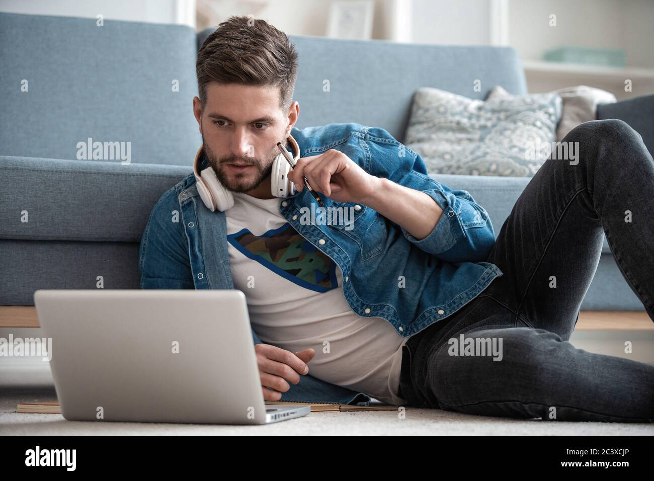 Handsome modern man designer working on laptop online, using internet ...