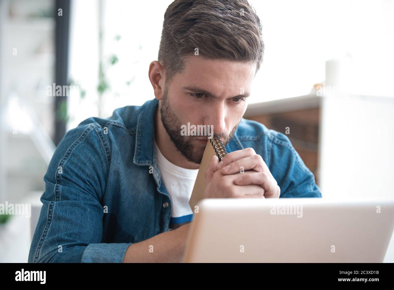 Handsome modern man designer working on laptop online, using internet ...