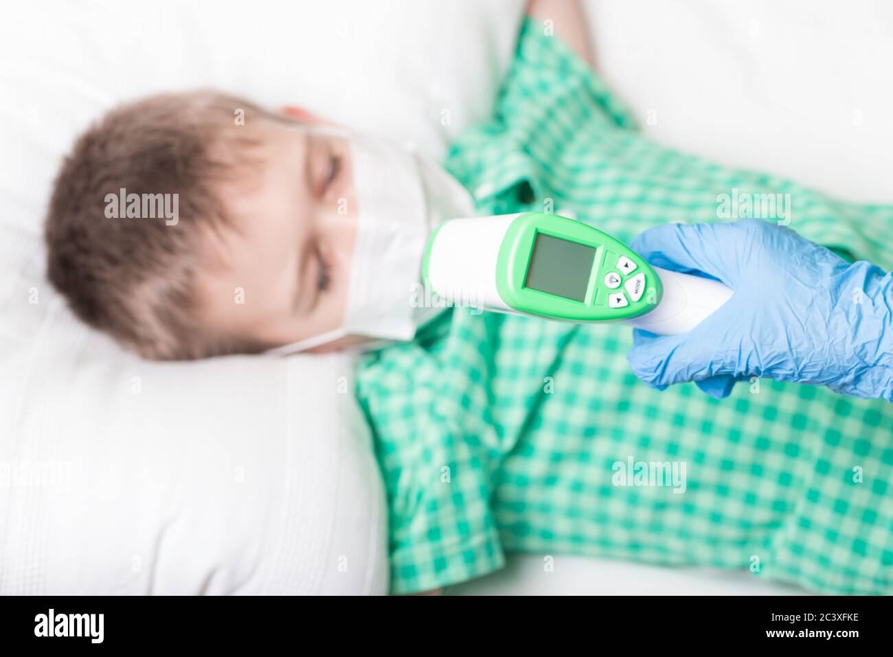 Sleeping boy measure the temperature with a thermometer Stock Photo - Alamy