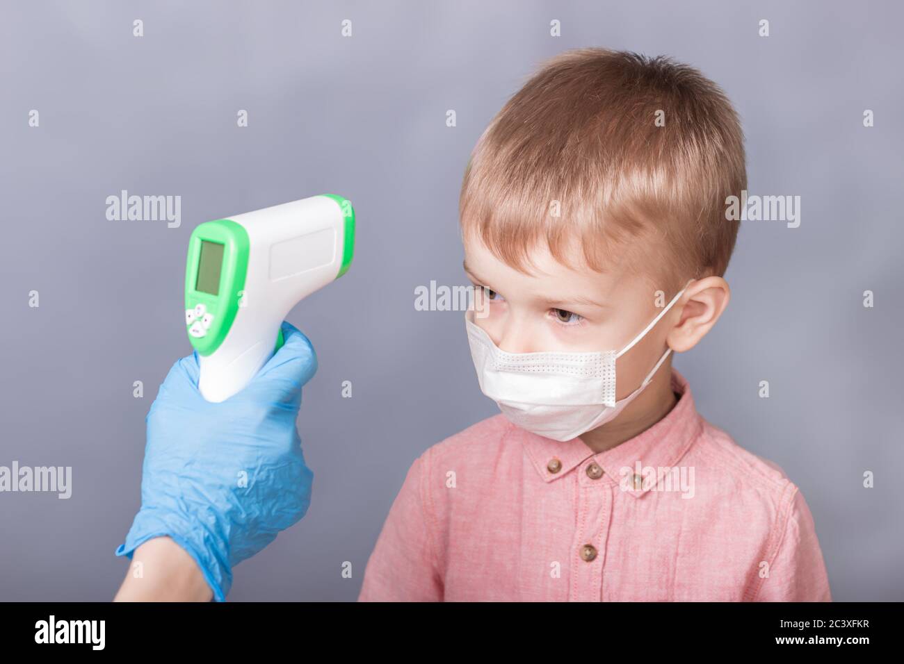 Little boy measure the temperature with a thermometer Stock Photo - Alamy